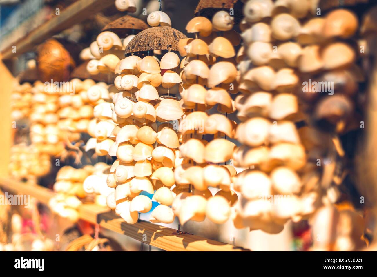Bunch of pretty seashell decorations hanging on stall on nice market in ...