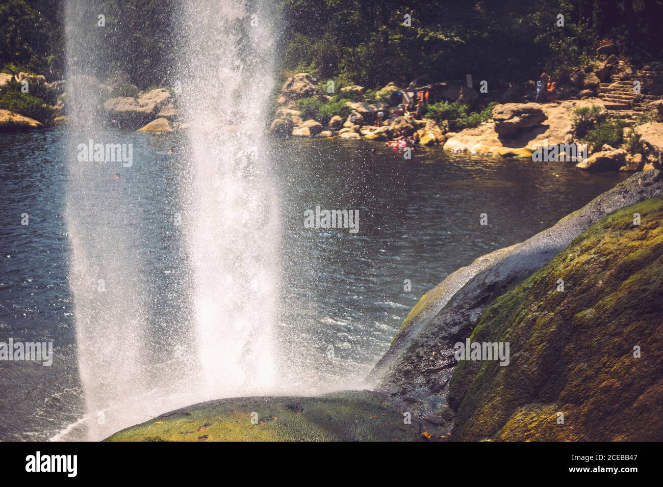 Breathtaking view of thin stream of water falling from cliff in ...