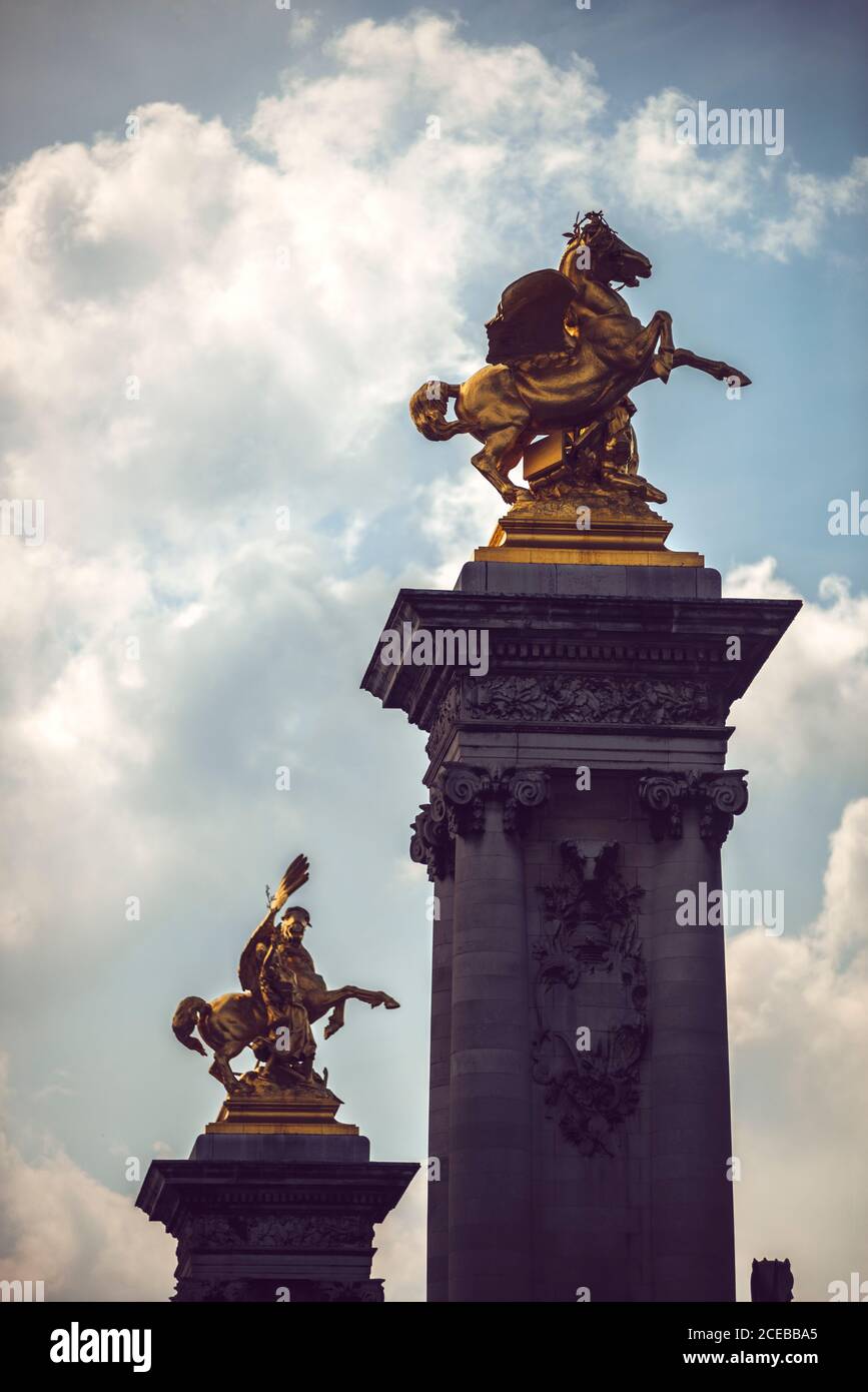 Columns on Alexander III bridge with gold covered statues of horse in ...