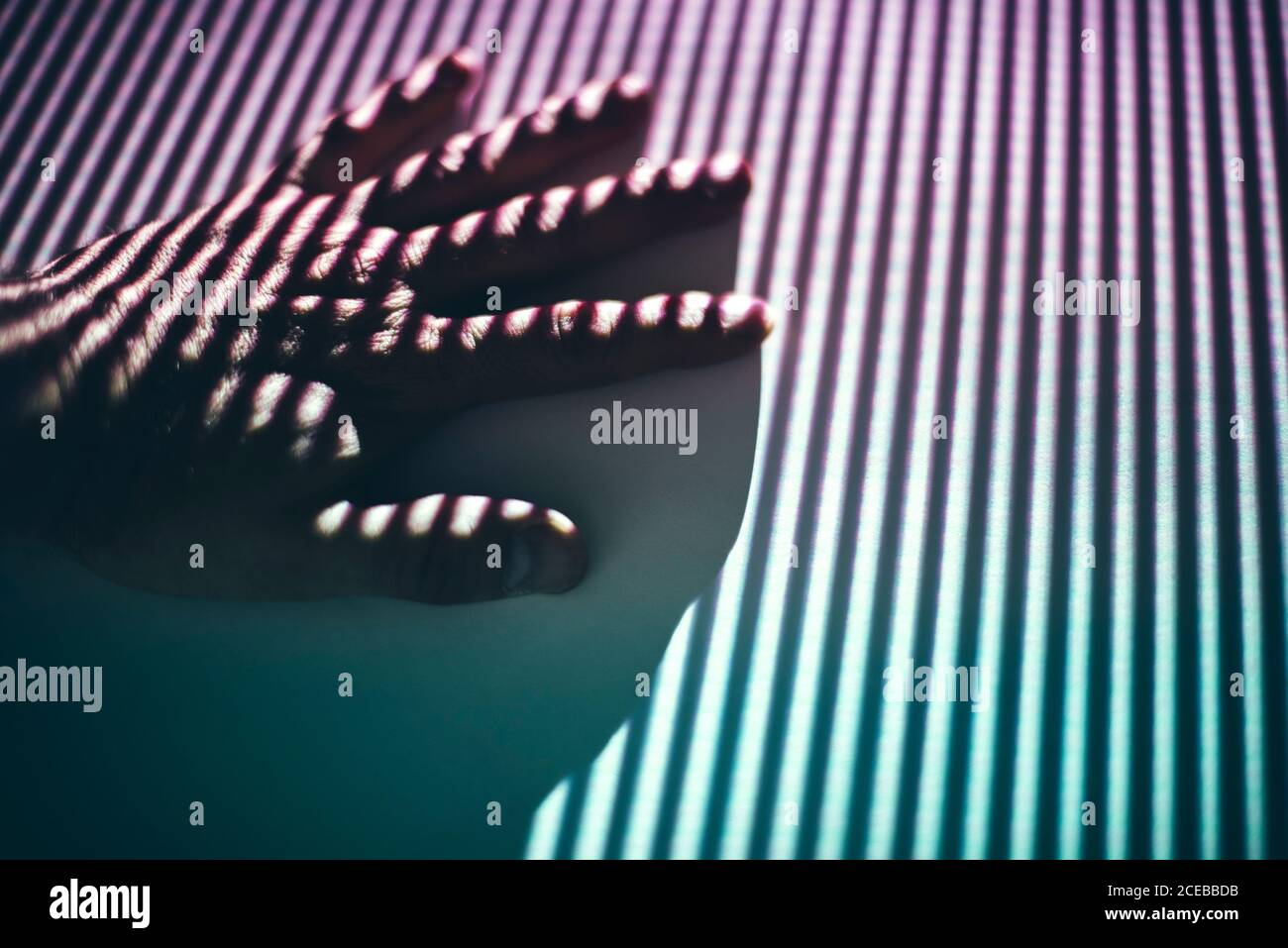 Hand on surface with striped shadow Stock Photo - Alamy