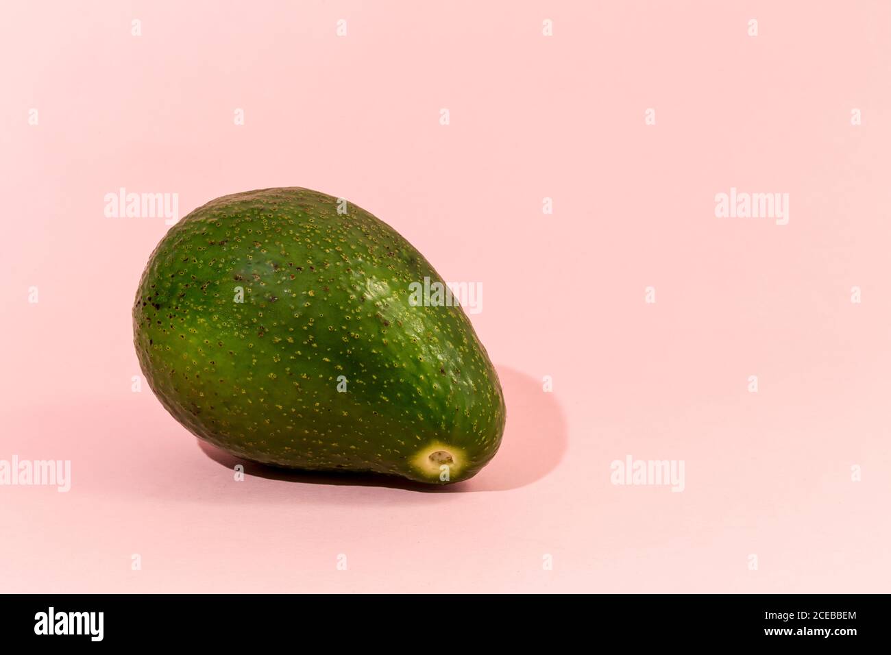 Fresh avocados on pink background. Isolated Stock Photo - Alamy