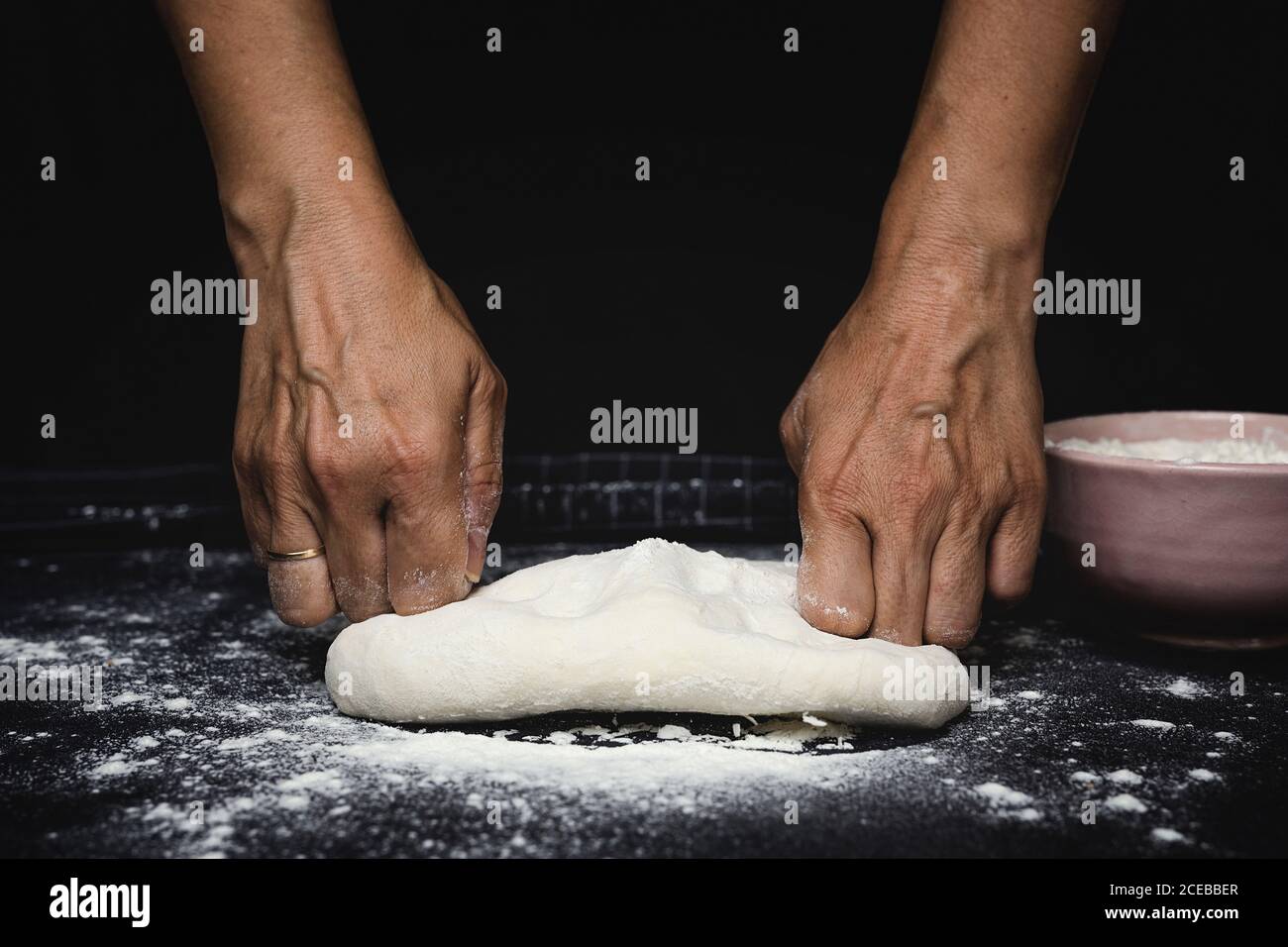 Woman's hands kneading bread on kitchen table Stock Photo - Alamy