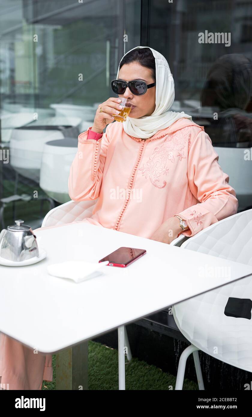Nice Moroccan Woman with hijab and typical Arabic dress,drinking tea ...