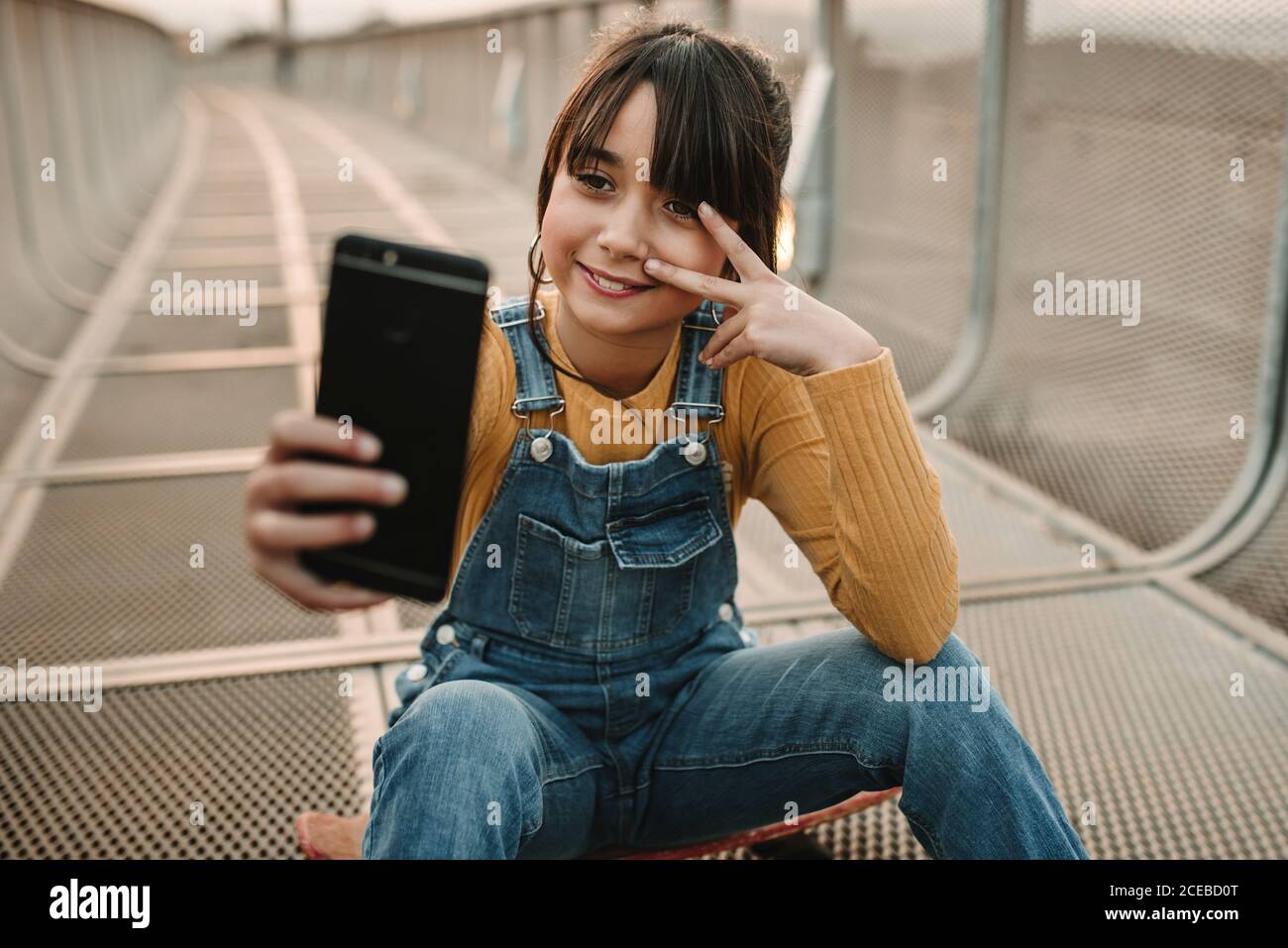 Funny girl taking selfie on smartphone on walkway Stock Photo - Alamy