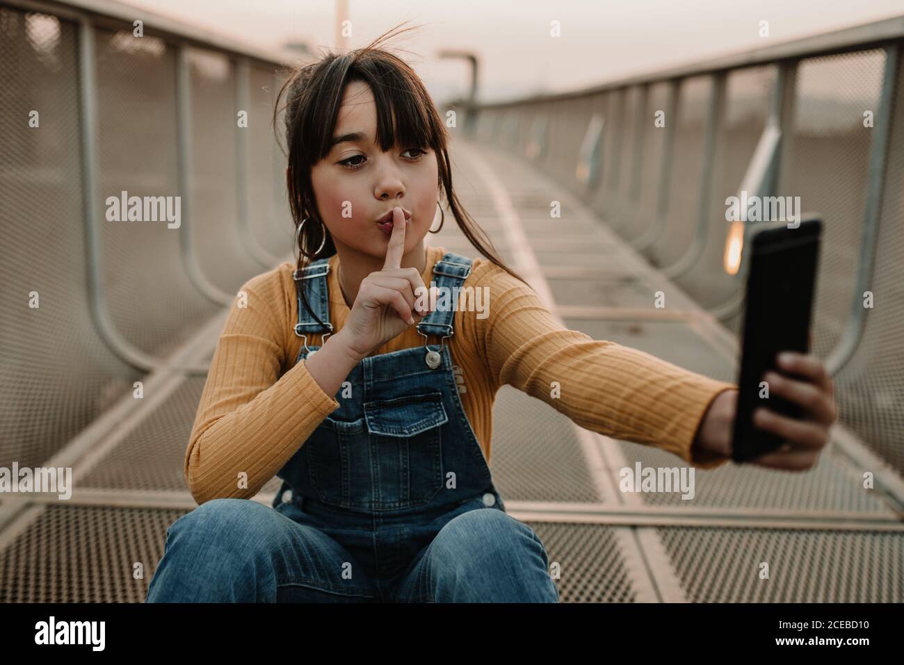 Funny girl taking selfie on smartphone on walkway Stock Photo - Alamy