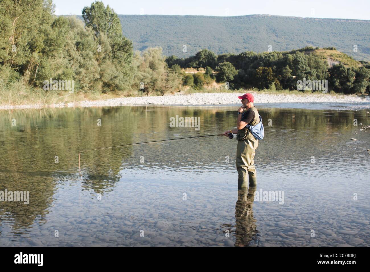 man standing in water and fishing Stock Photo - Alamy