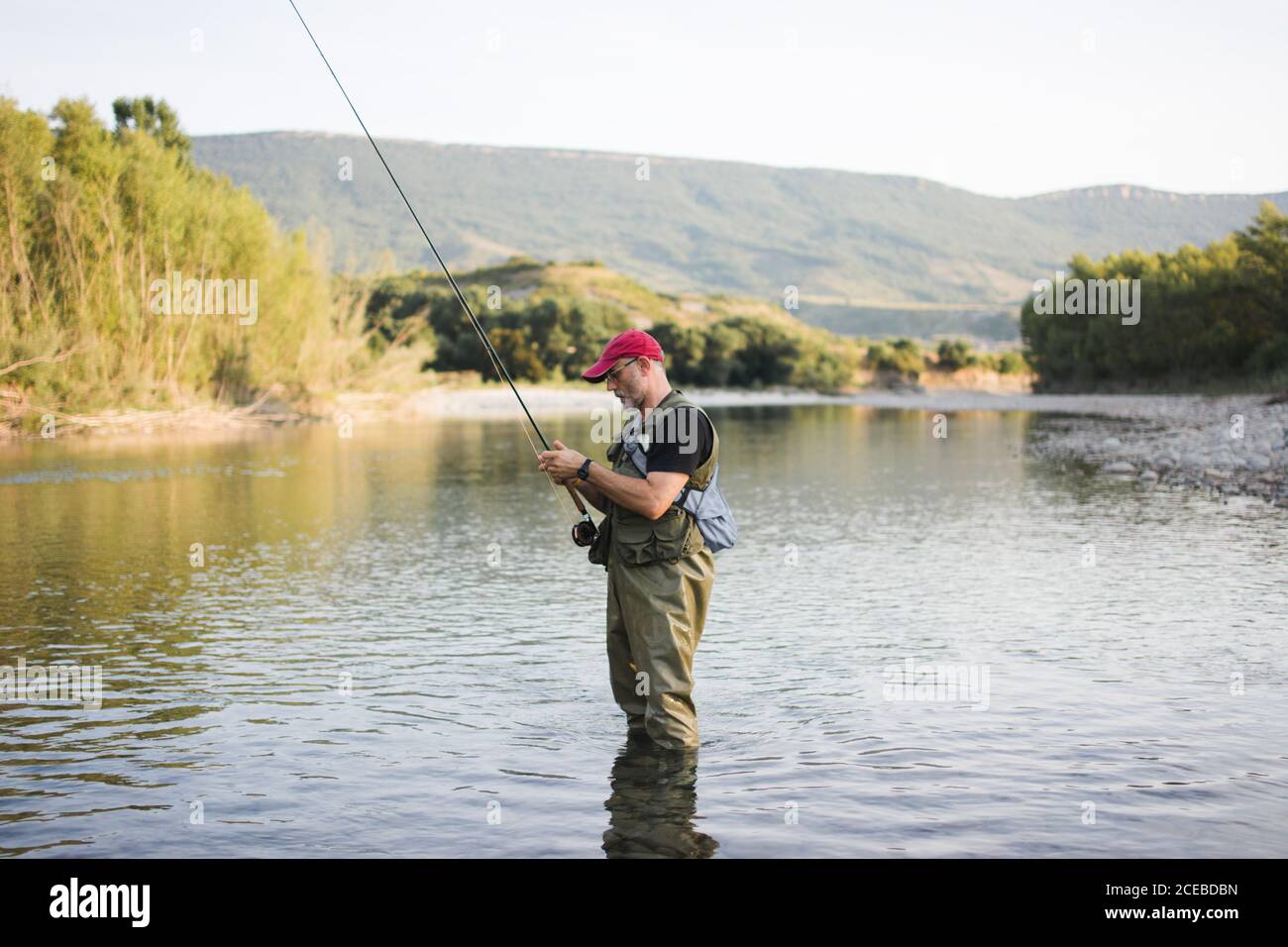 man standing in water and fishing Stock Photo - Alamy