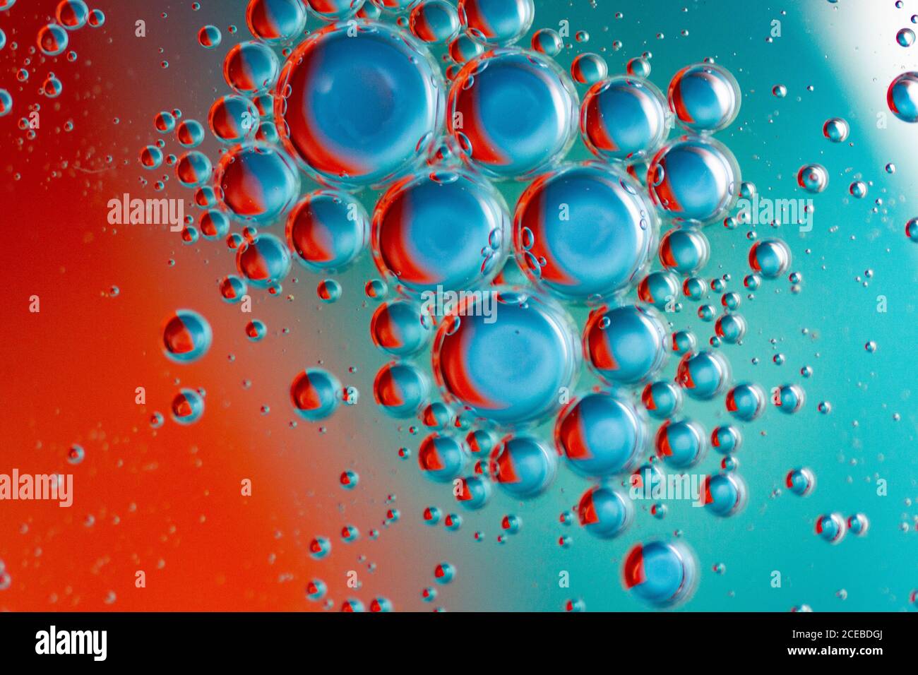 From above closeup many abstract red and blue water bubbles on glass on ...