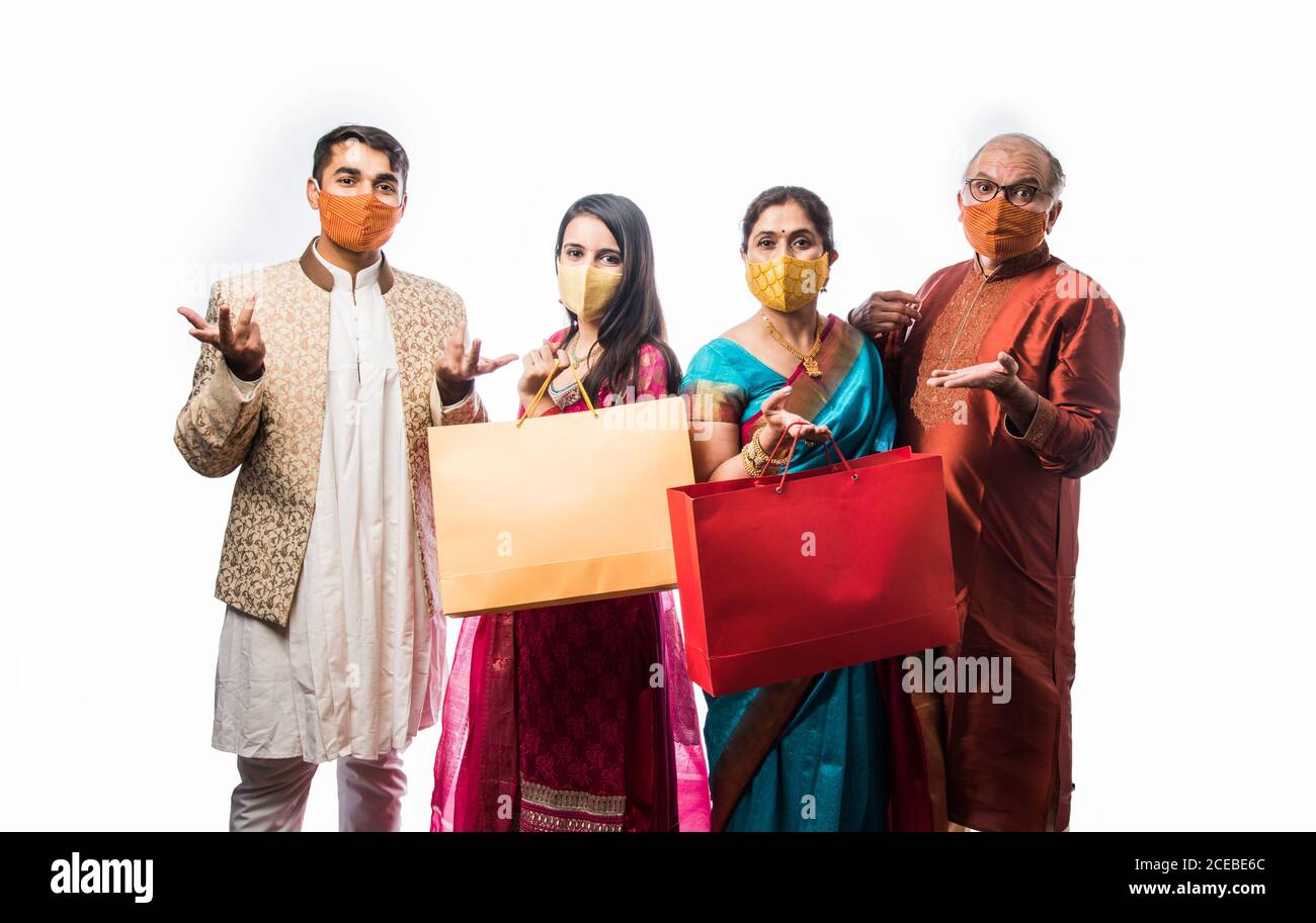 Cheerful Indian family shopping for Diwali festival or wedding wearing ...