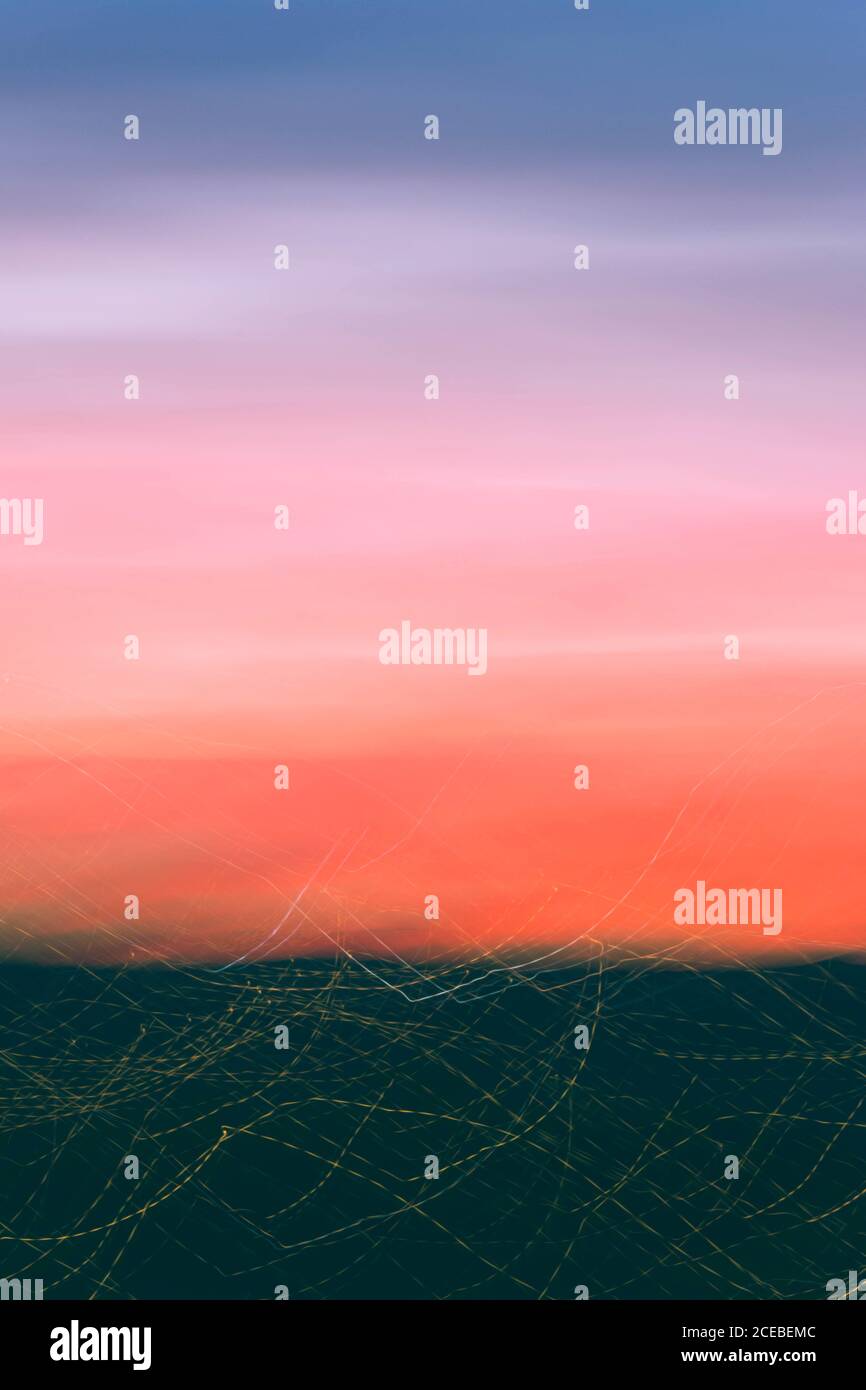 Background of colorful sunset sky in blue and red colors with trail of ...