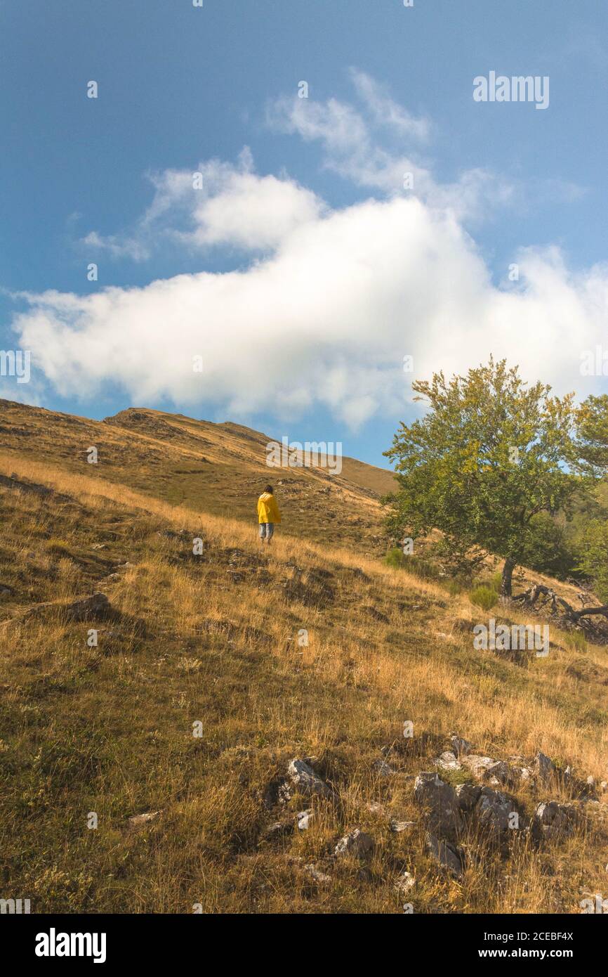 anonymous person standing on hill Stock Photo - Alamy