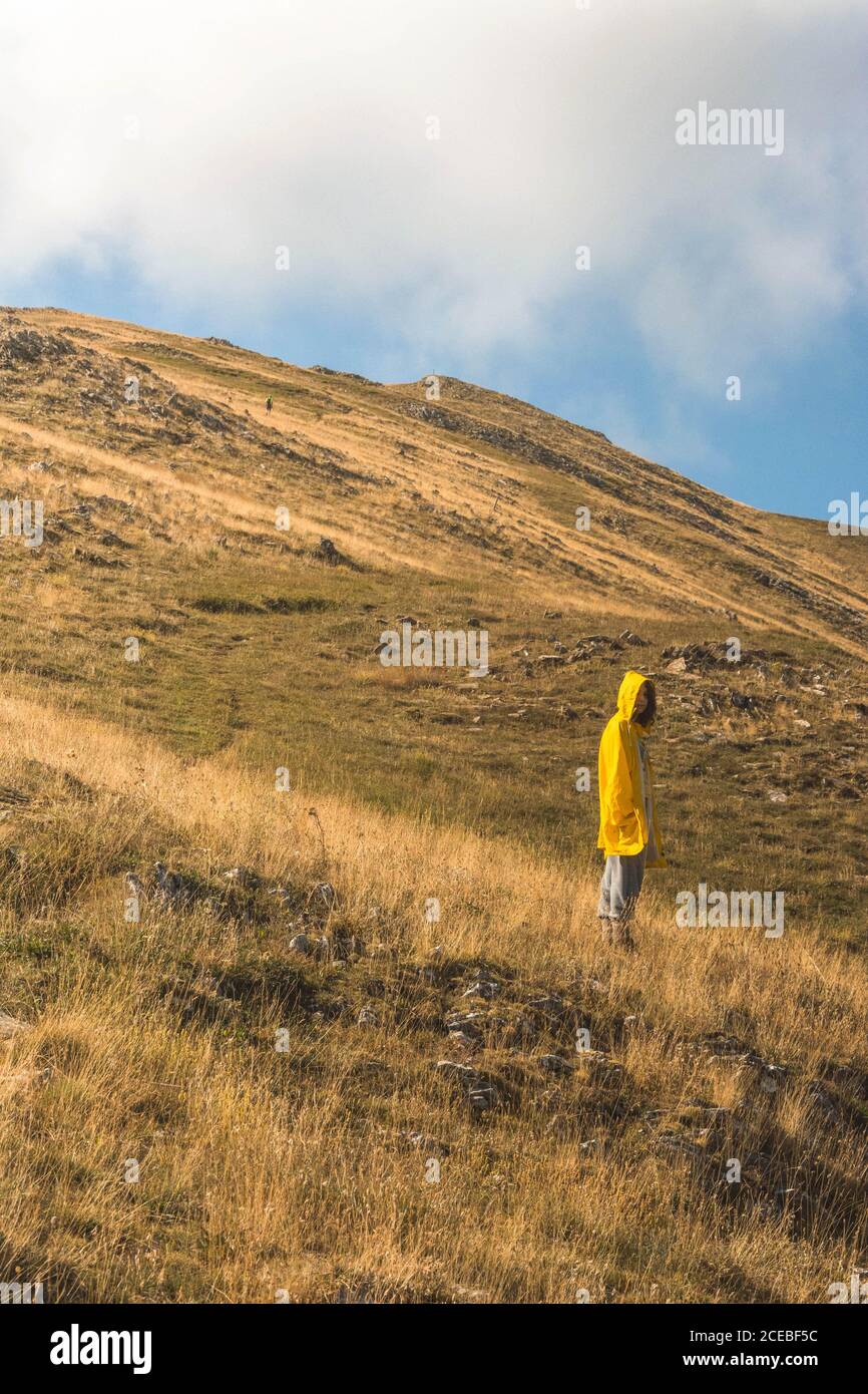 anonymous person standing on hill Stock Photo - Alamy