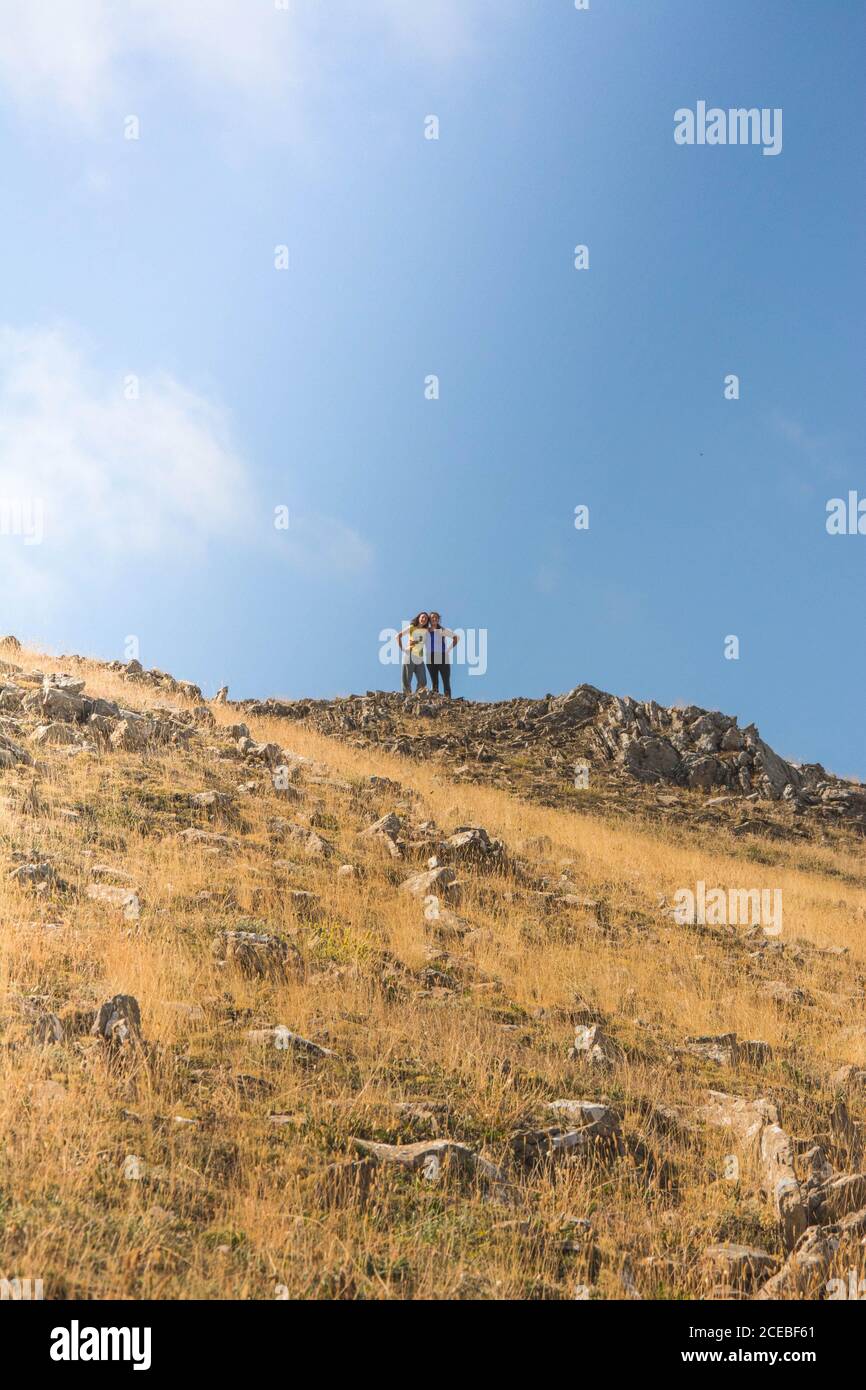 anonymous couple standing on hill Stock Photo - Alamy