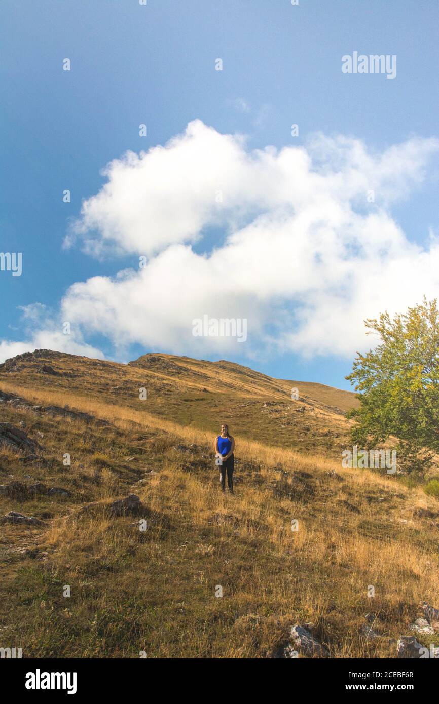 anonymous person standing on hill Stock Photo - Alamy