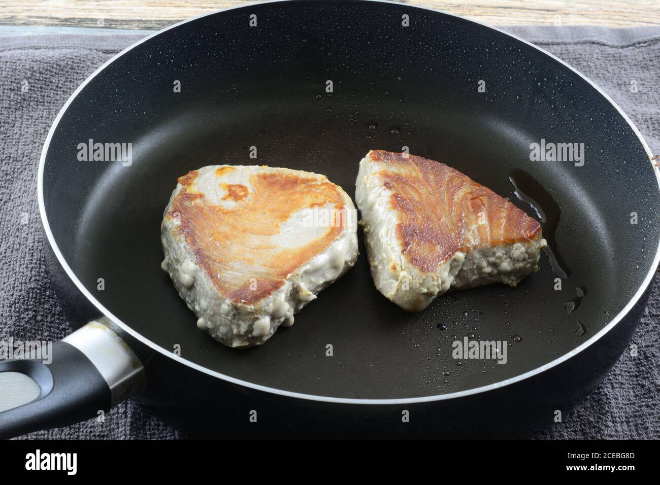 Cooking fresh ahi tuna fillet steaks with olive oil in frying pan Stock ...