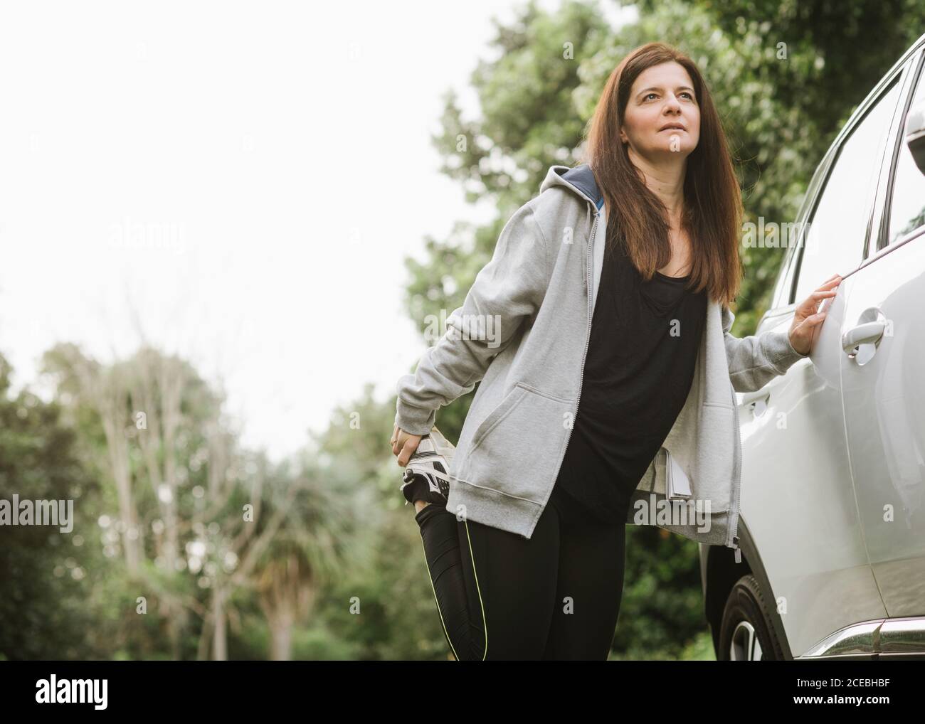 Stretching woman car hi-res stock photography and images - Alamy