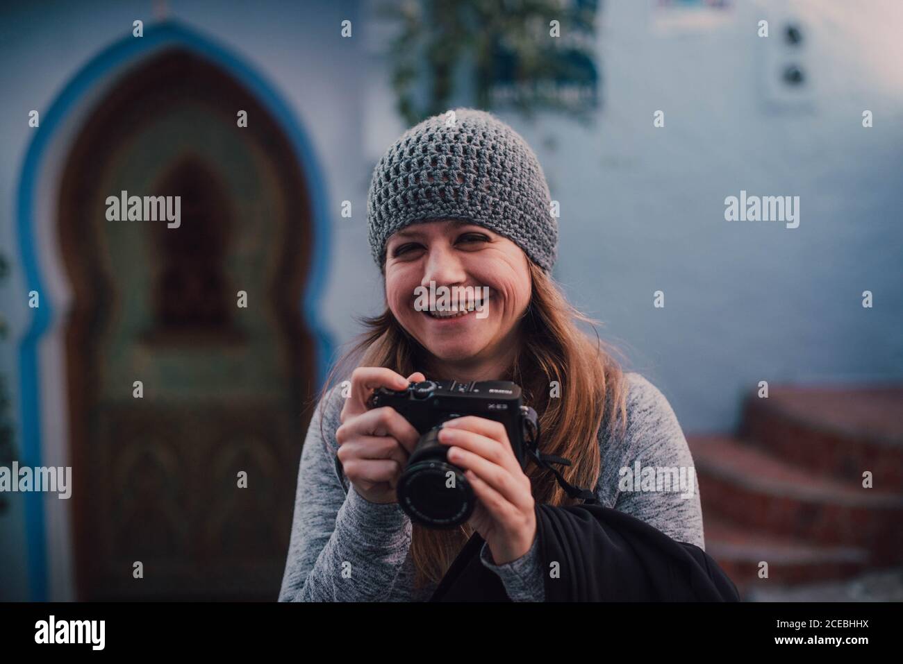 Laughing Woman with camera Stock Photo - Alamy