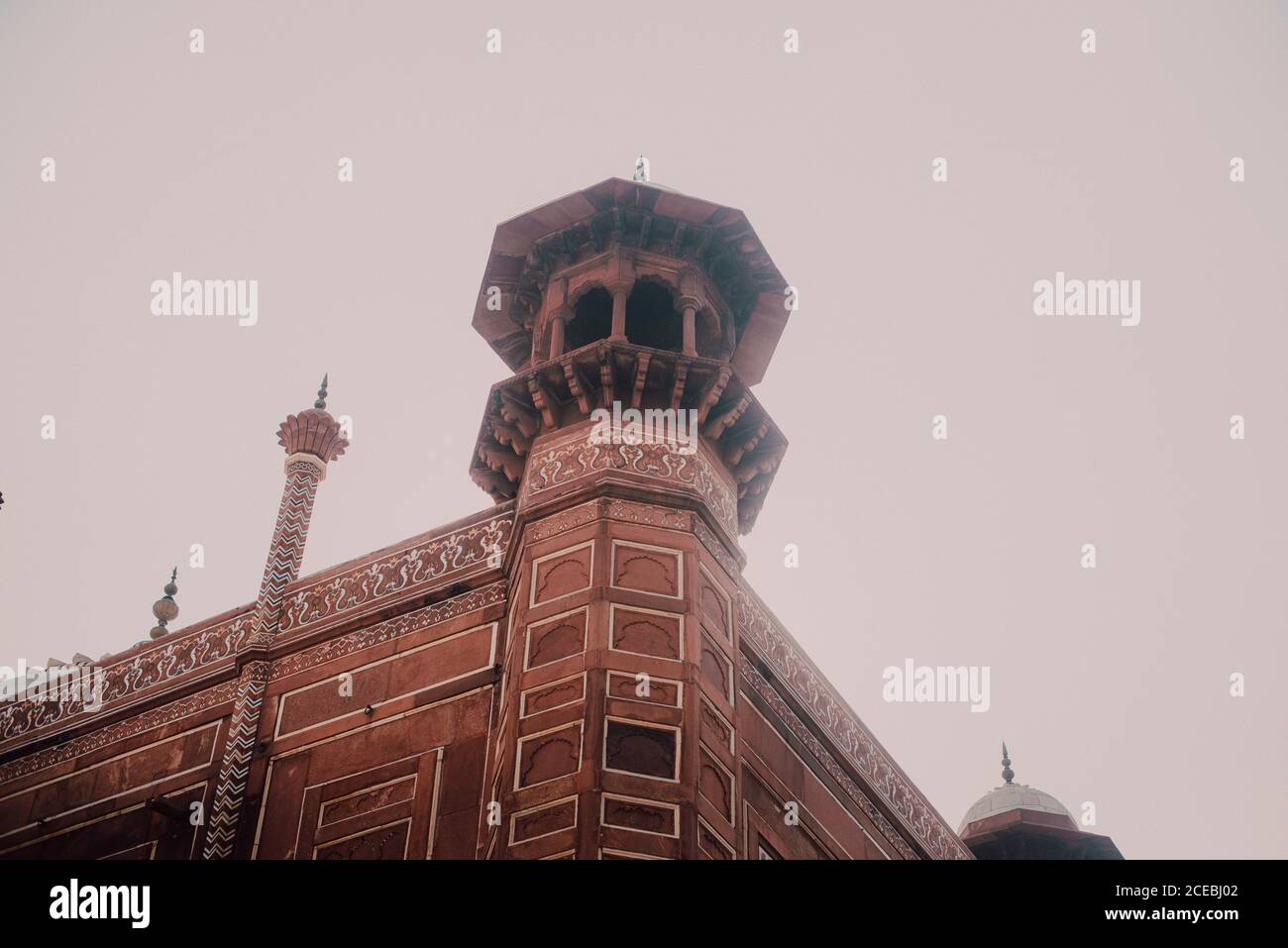 From below facade of red ancient?monastery and rainy heaven Stock Photo ...