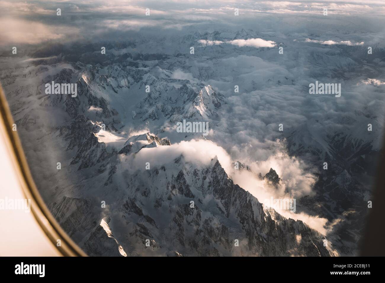 Magnificent view of clouds and snow of beautiful Alps from window of ...