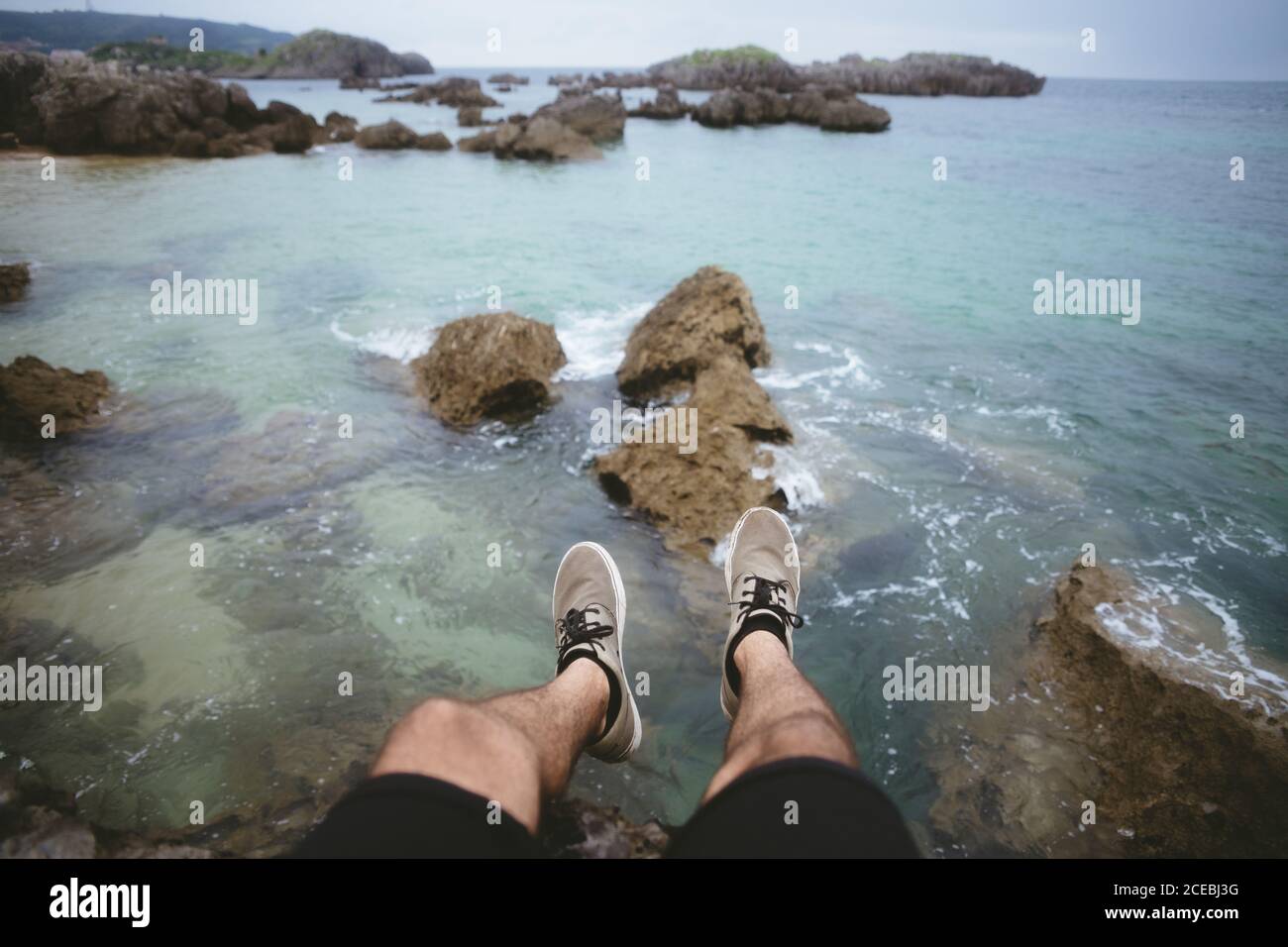 Man hanging on cliff hi-res stock photography and images - Alamy