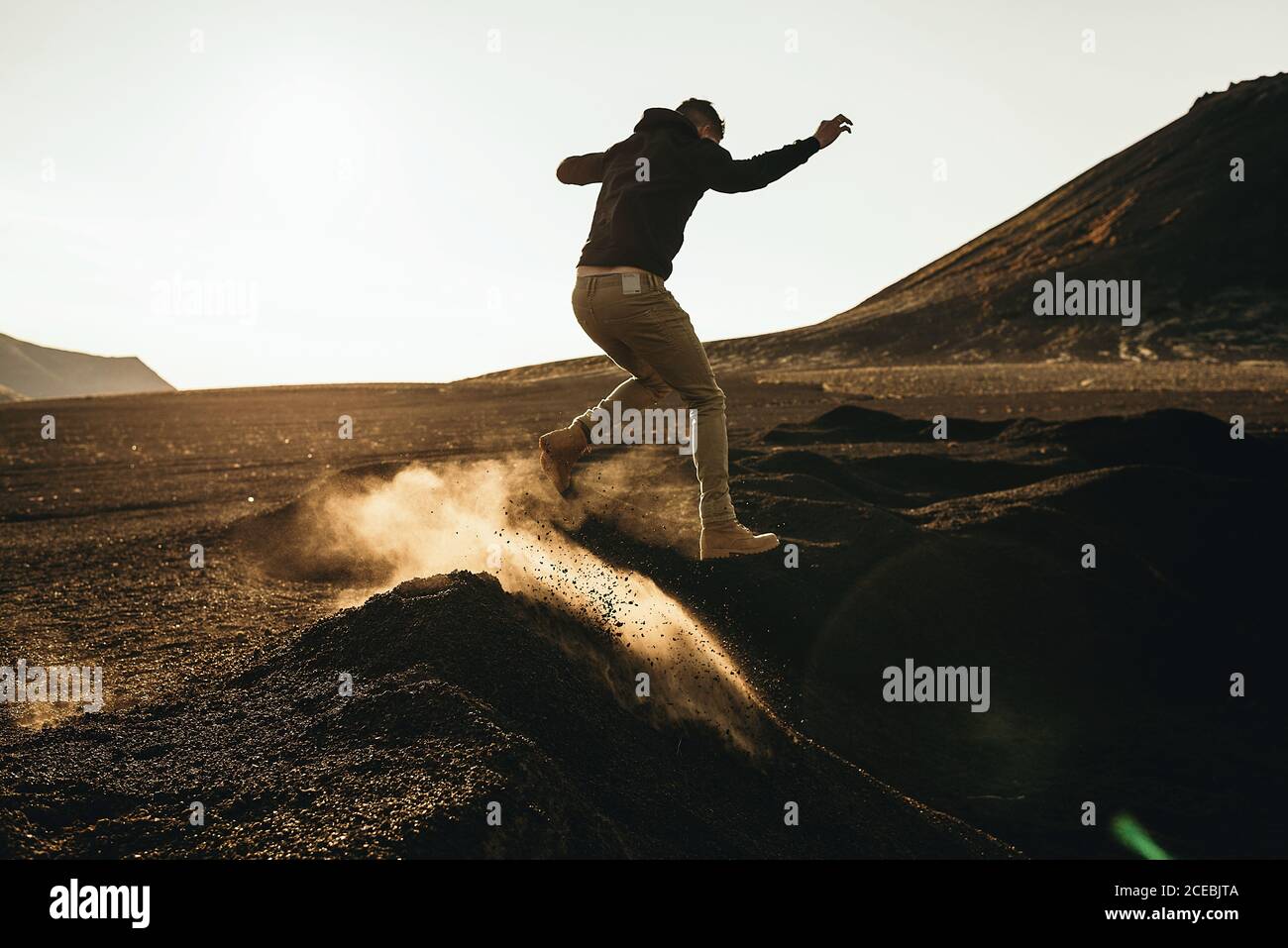 man jumping on dry ground Stock Photo - Alamy