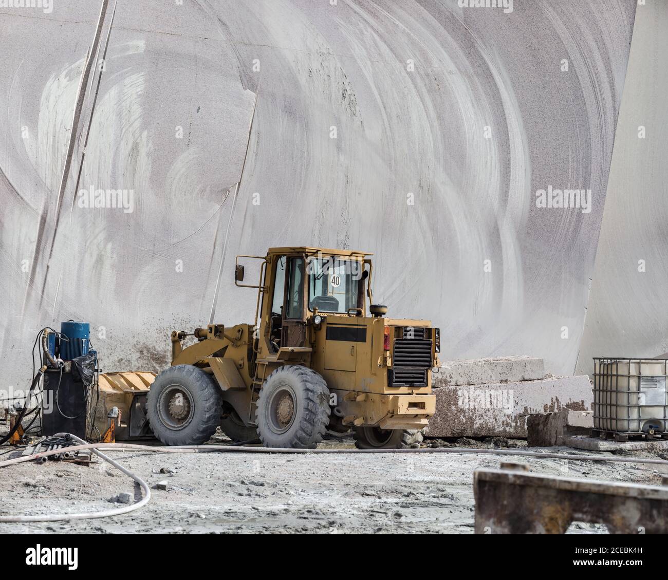 Block and heavy machinery in quarry Stock Photo - Alamy