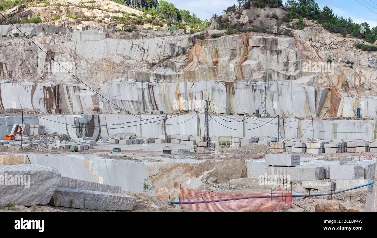 Block and heavy machinery in quarry Stock Photo - Alamy