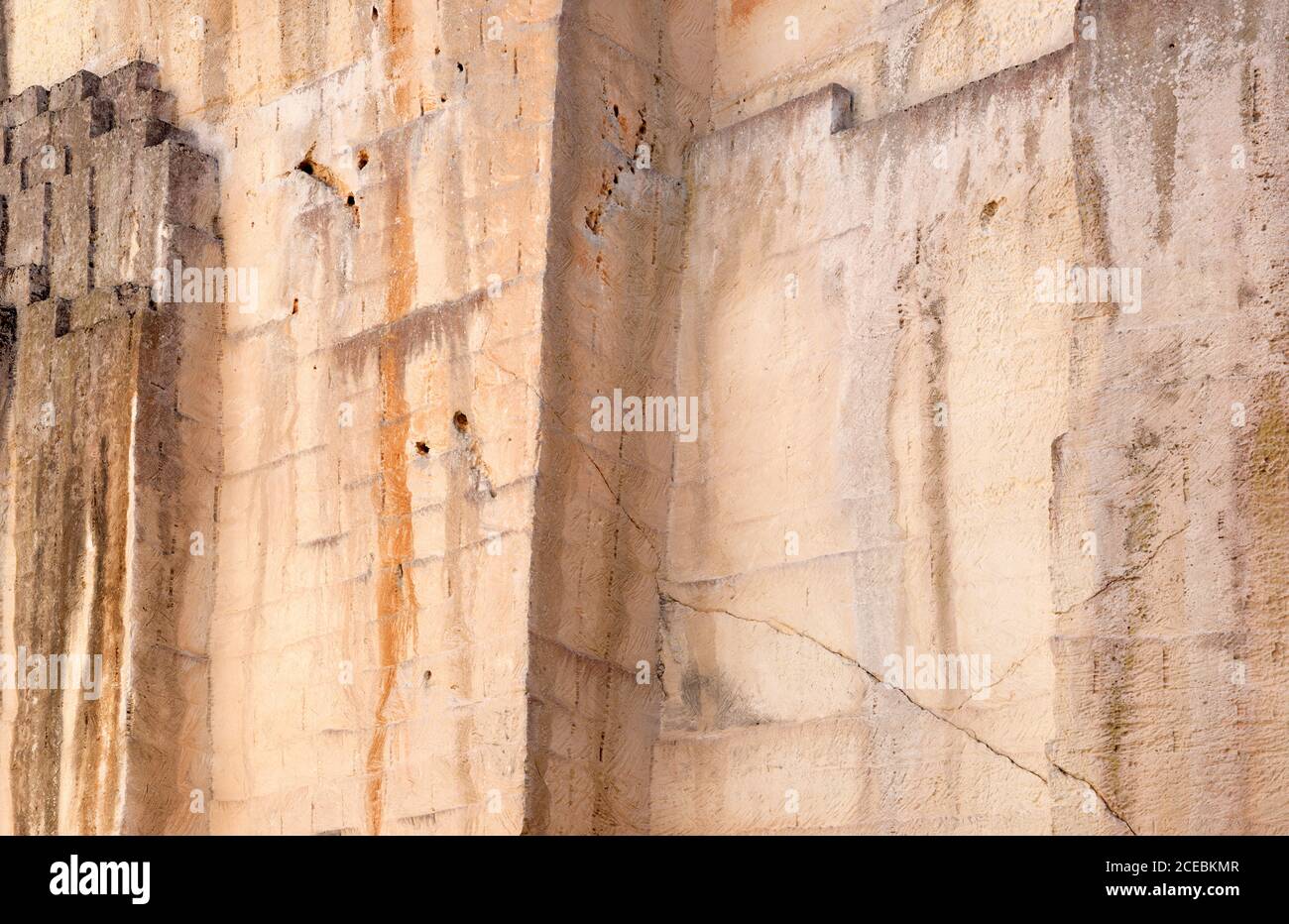 Rough wall of stone quarry Stock Photo - Alamy