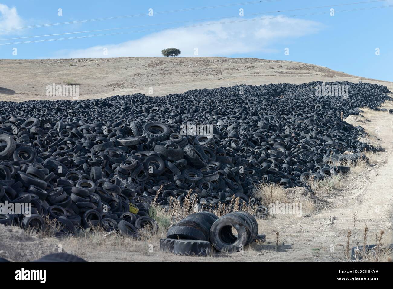 Huge pile of old auto tires between meadow Stock Photo - Alamy