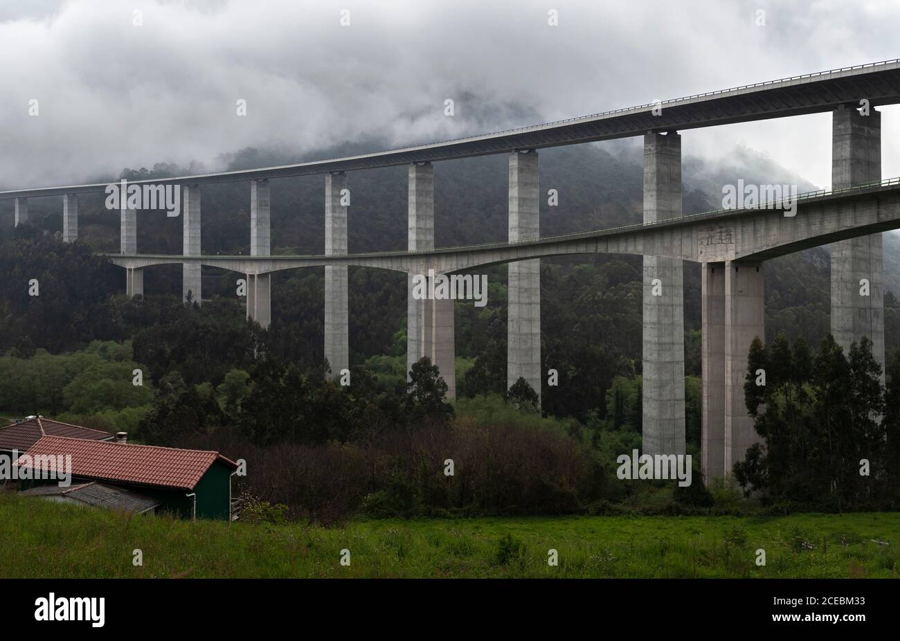 landscape of beautiful viaduct with high pillars surrounded by green ...