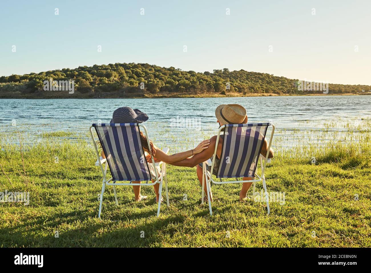 Beach chairs back view holding hands hi-res stock photography and ...
