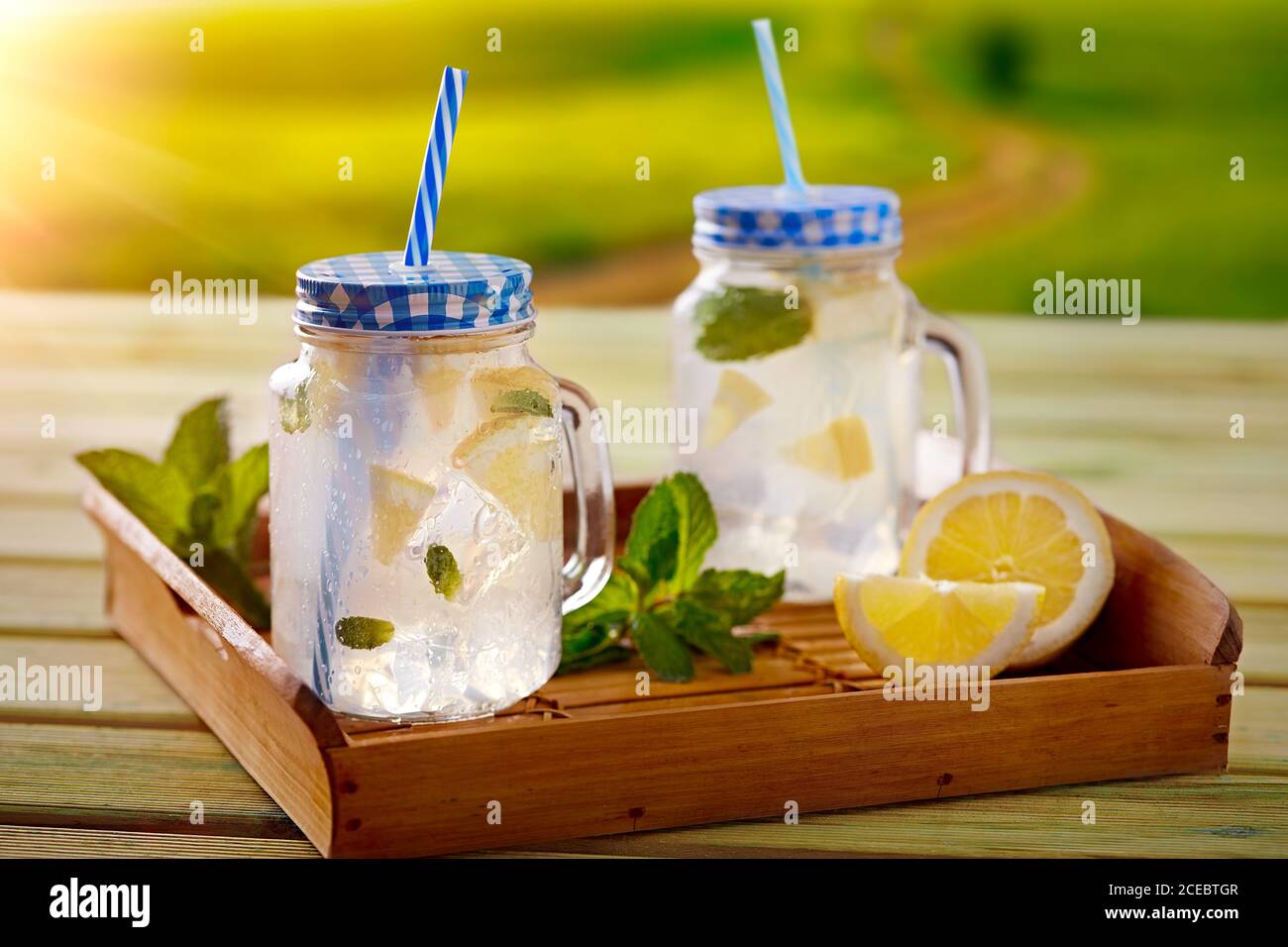 Wooden tray with served refreshing lemonade Stock Photo - Alamy