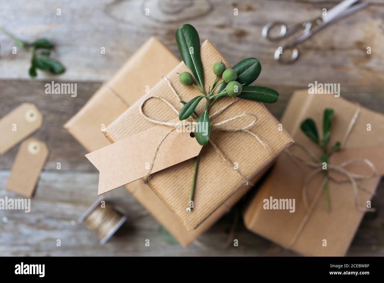 homemade wrapped Presents on a wood table Stock Photo - Alamy