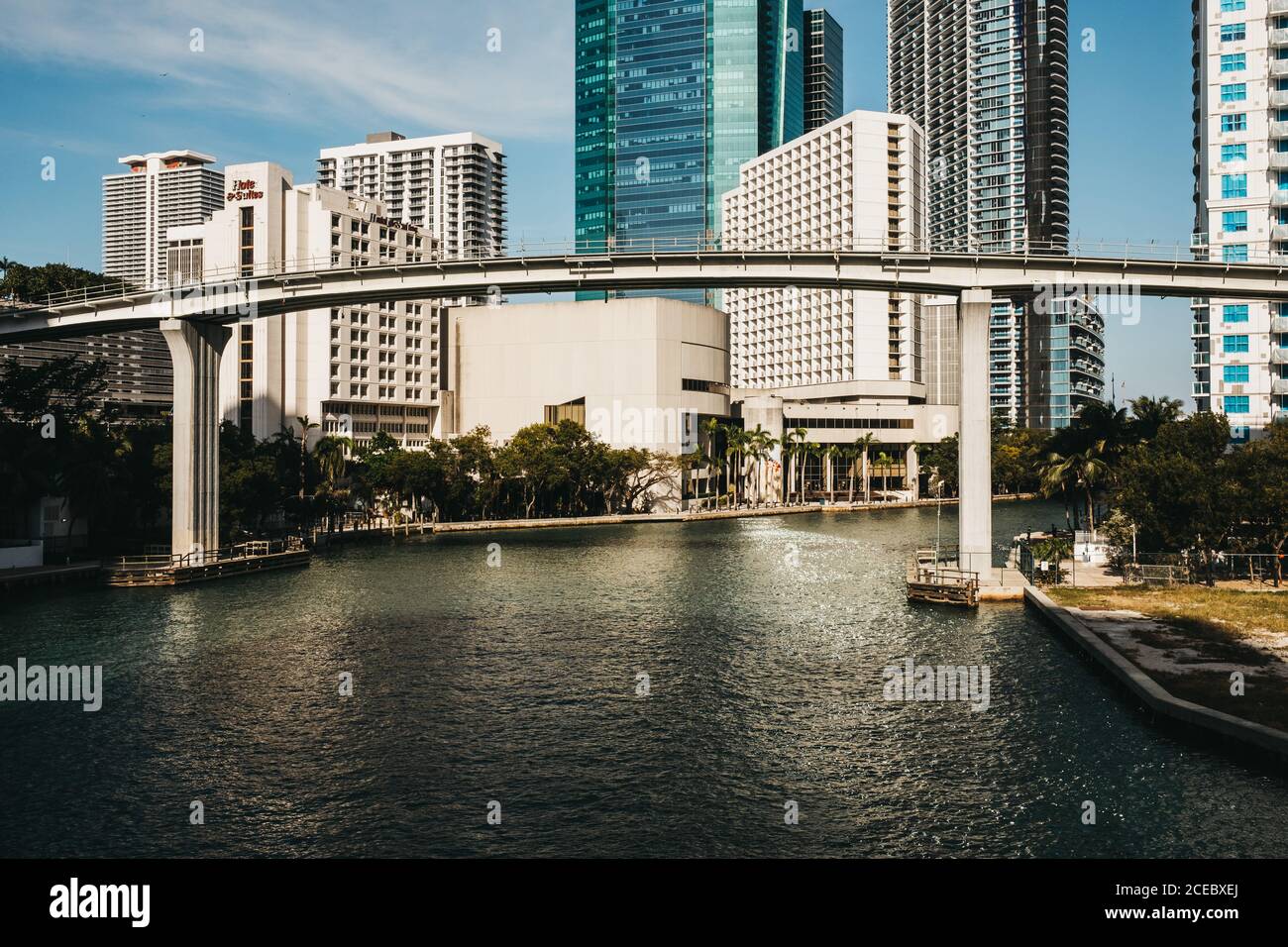 View of calm river flowing under modern bridge through magnificent city ...