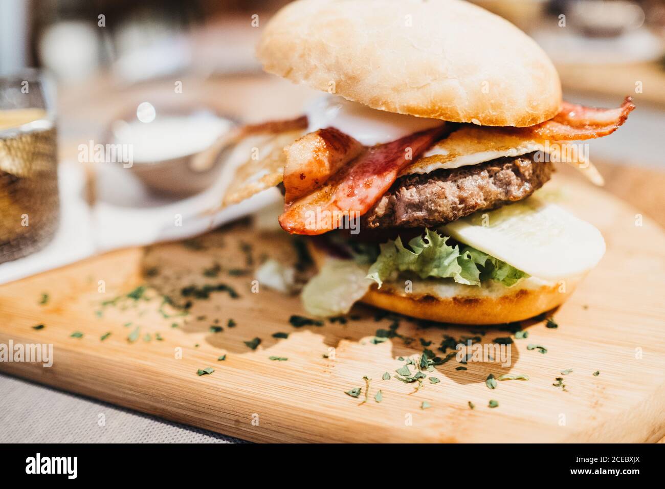 From above close-up shot of delicious burger served on wood board with ...