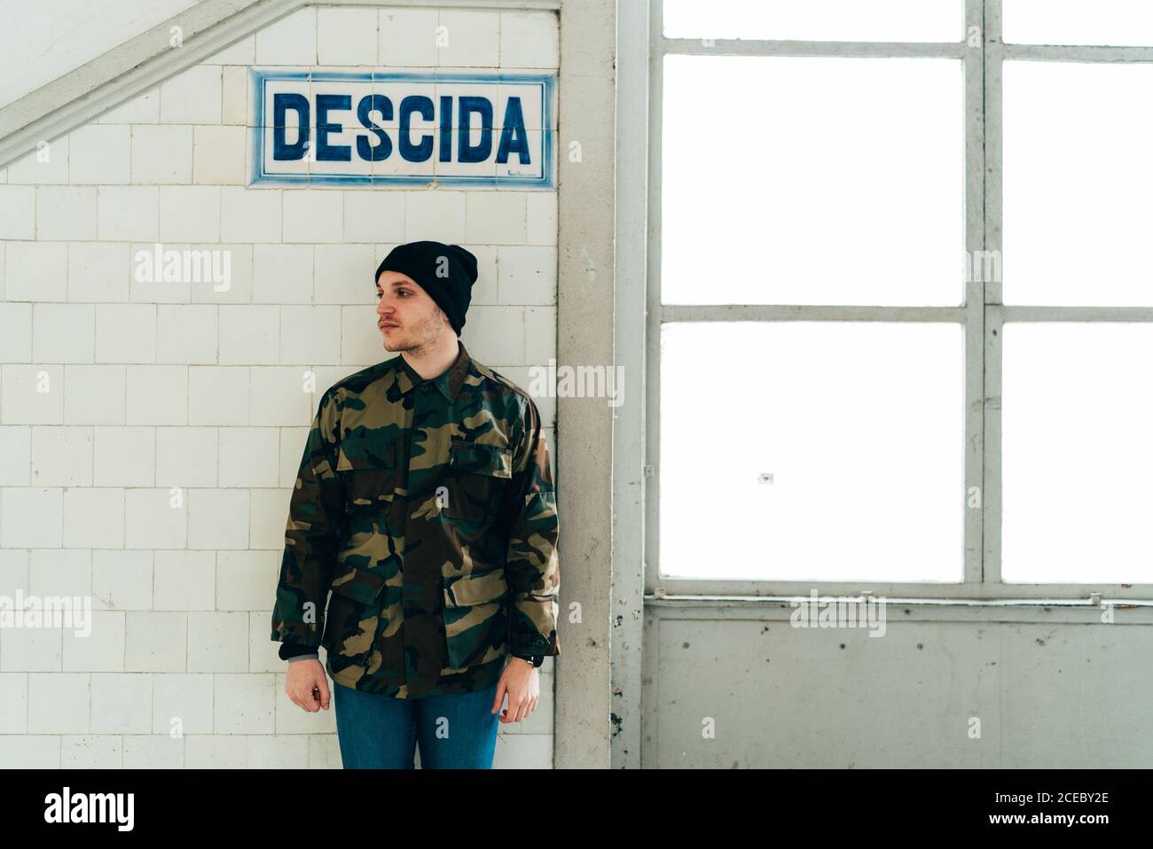 Adult man standing at window near the stairs in entrance hall Stock ...