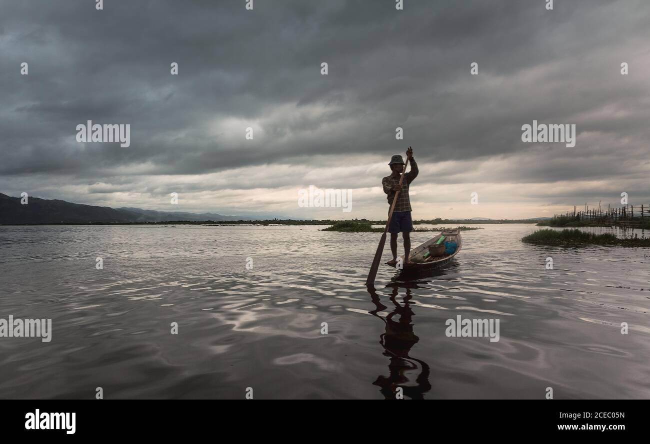 Anonymous fisherman standing boat hi-res stock photography and images ...