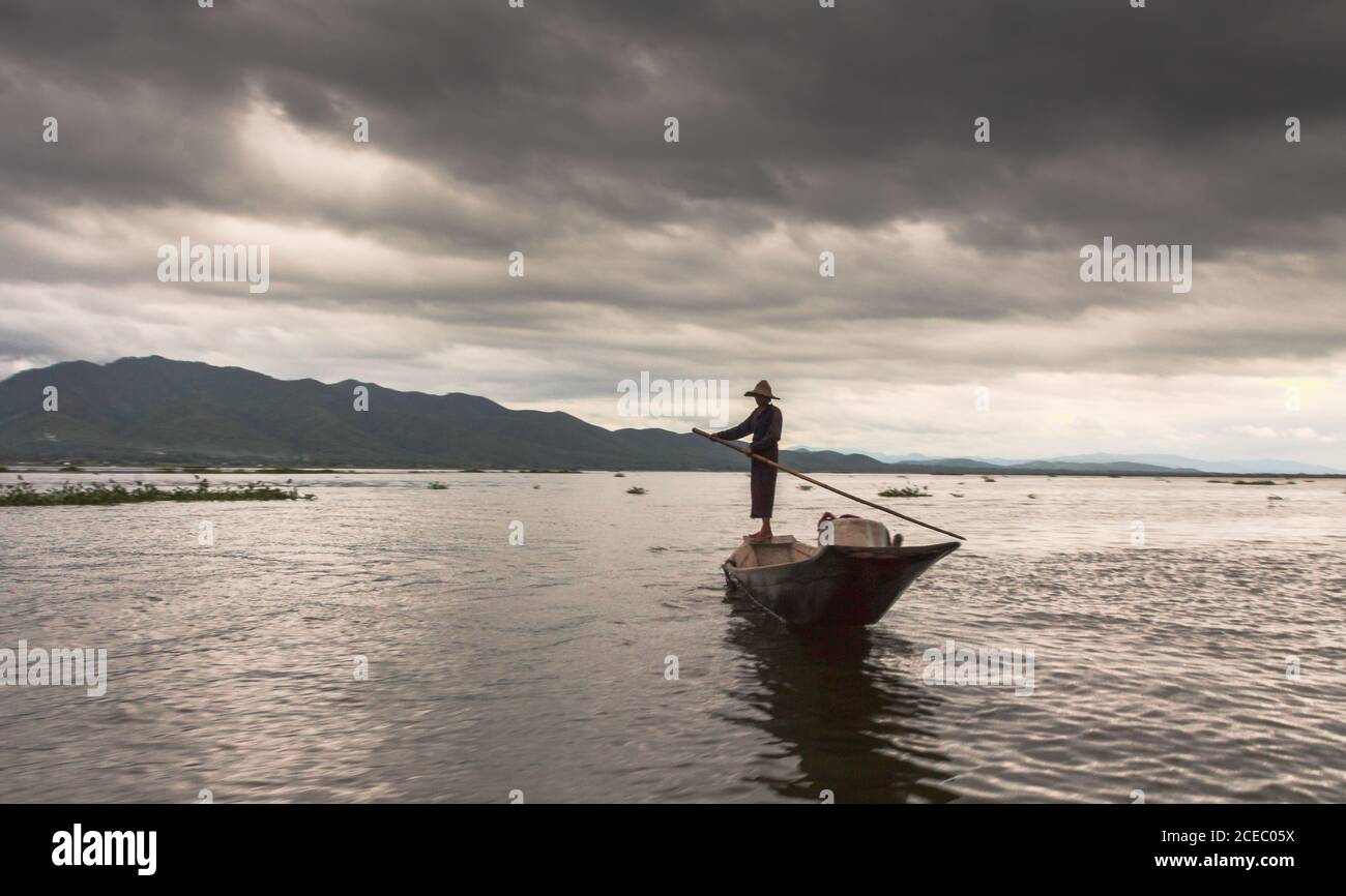 Shan, Myanmar - June, 25 2012: anonymous fisherman standing on boat ...