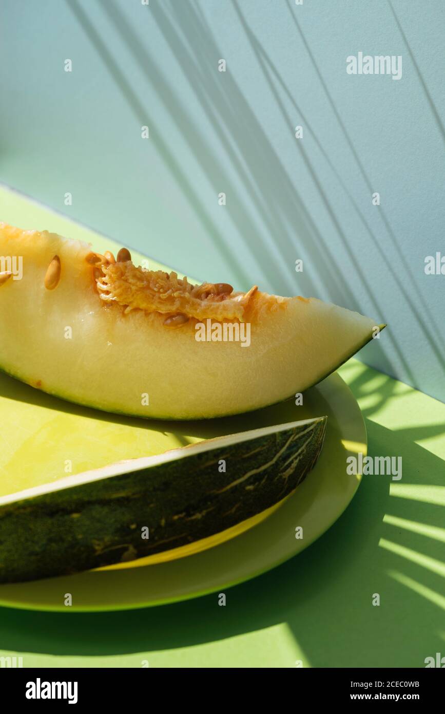 Half Melon toad skin cut into slice. Colorful summer theme. in blue and ...