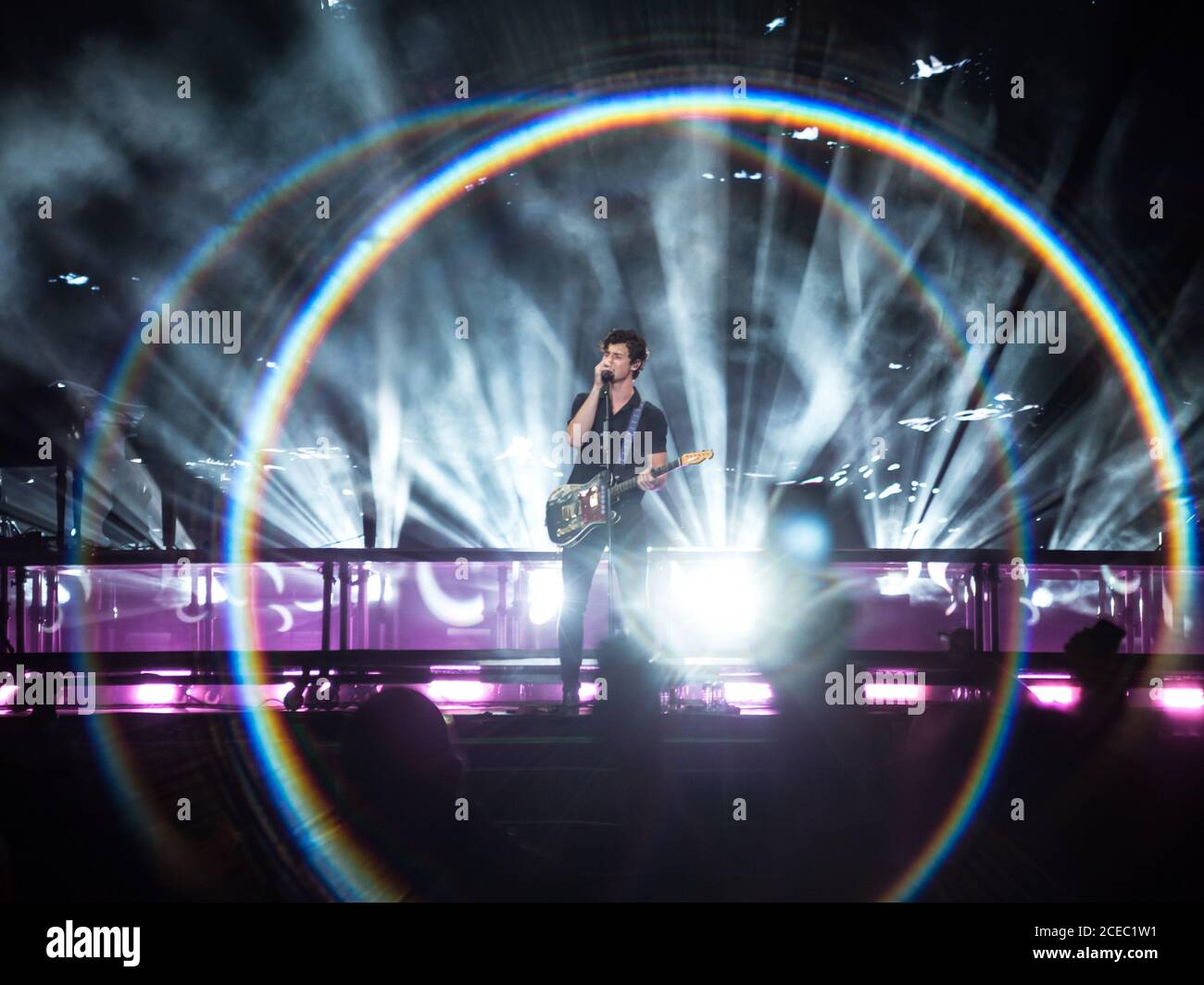 Singing man with guitar on stage during festival Stock Photo - Alamy