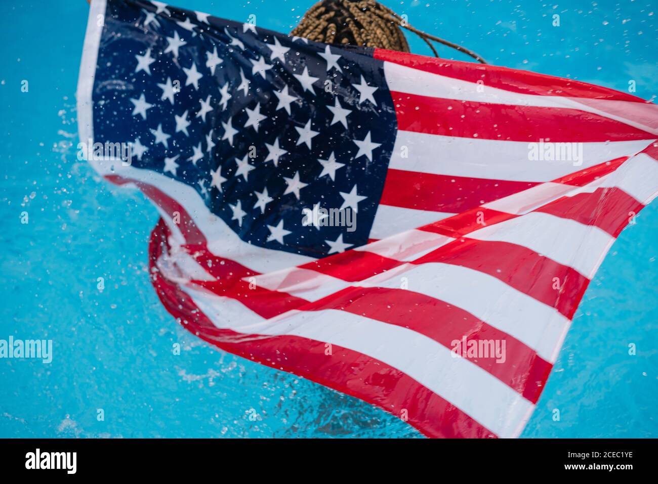 Woman inside the pool enjoying happy with American flag Stock Photo - Alamy