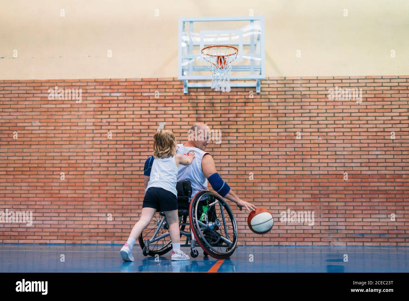 Disabled sport men and little girl in action while playing indoor ...
