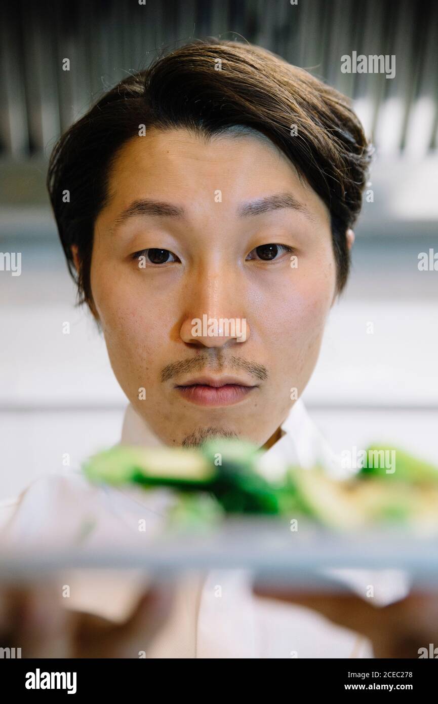 Japanese cook with food plate Stock Photo - Alamy