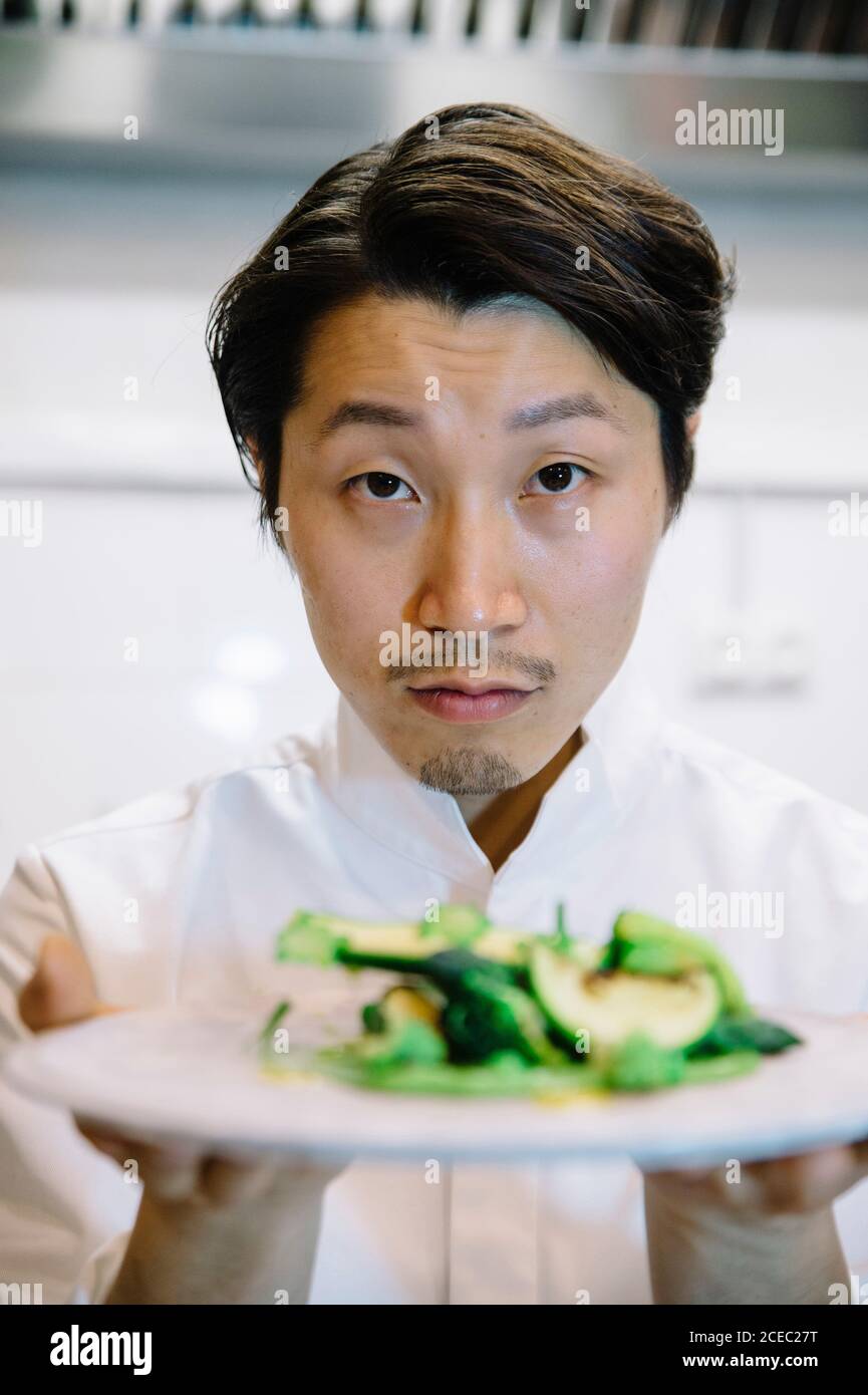 Japanese cook with food plate Stock Photo - Alamy