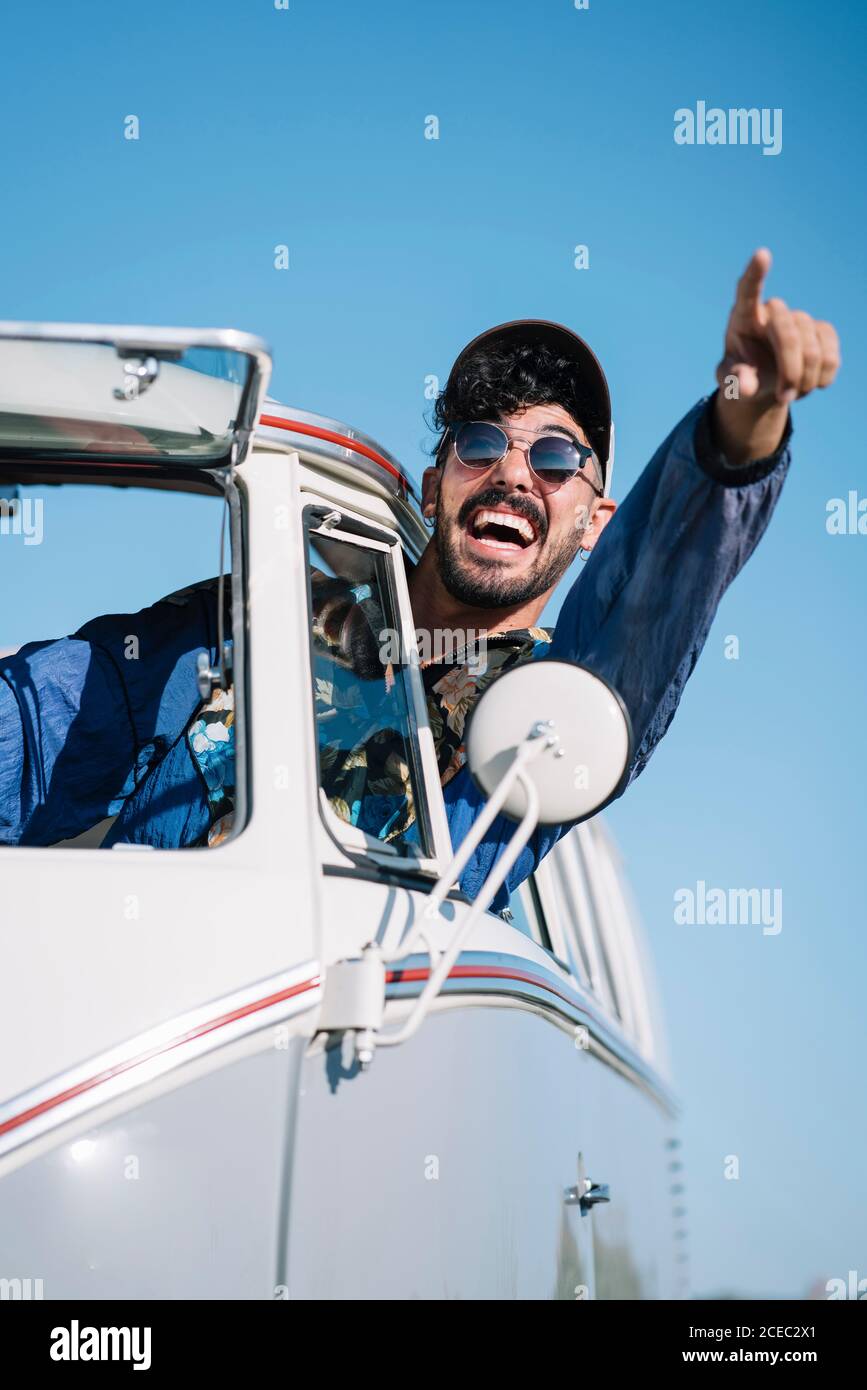 Man leaning out of car window hi-res stock photography and images - Alamy