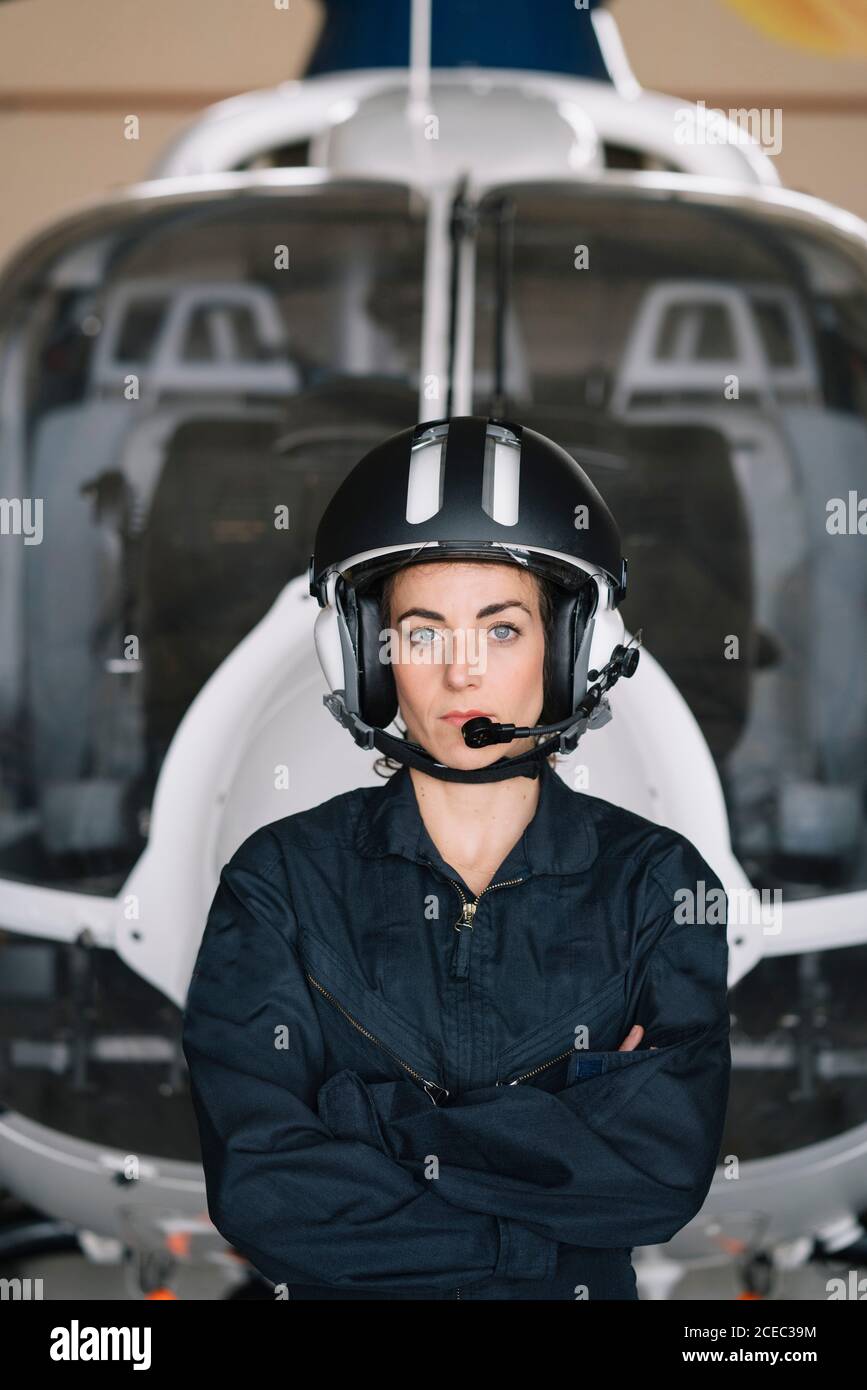 Portrait attractive Woman helicopter pilot In the hangar Stock Photo - Alamy