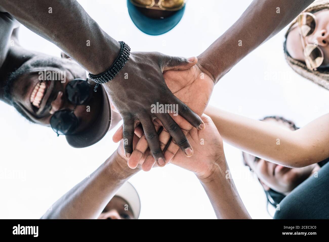 Group of friends stacking hands Stock Photo - Alamy