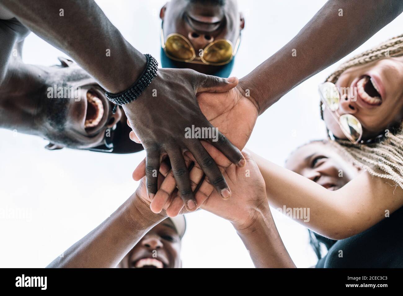 Group of friends stacking hands Stock Photo - Alamy
