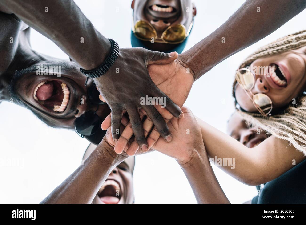 Group of friends stacking hands Stock Photo - Alamy