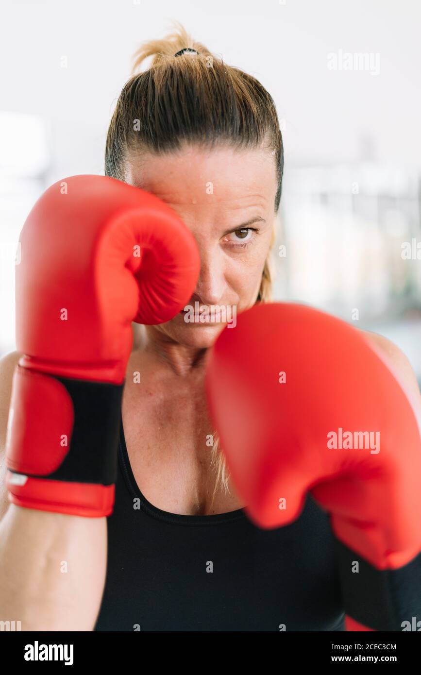 Adult Woman in boxing gloves standing in fighting position Stock Photo ...